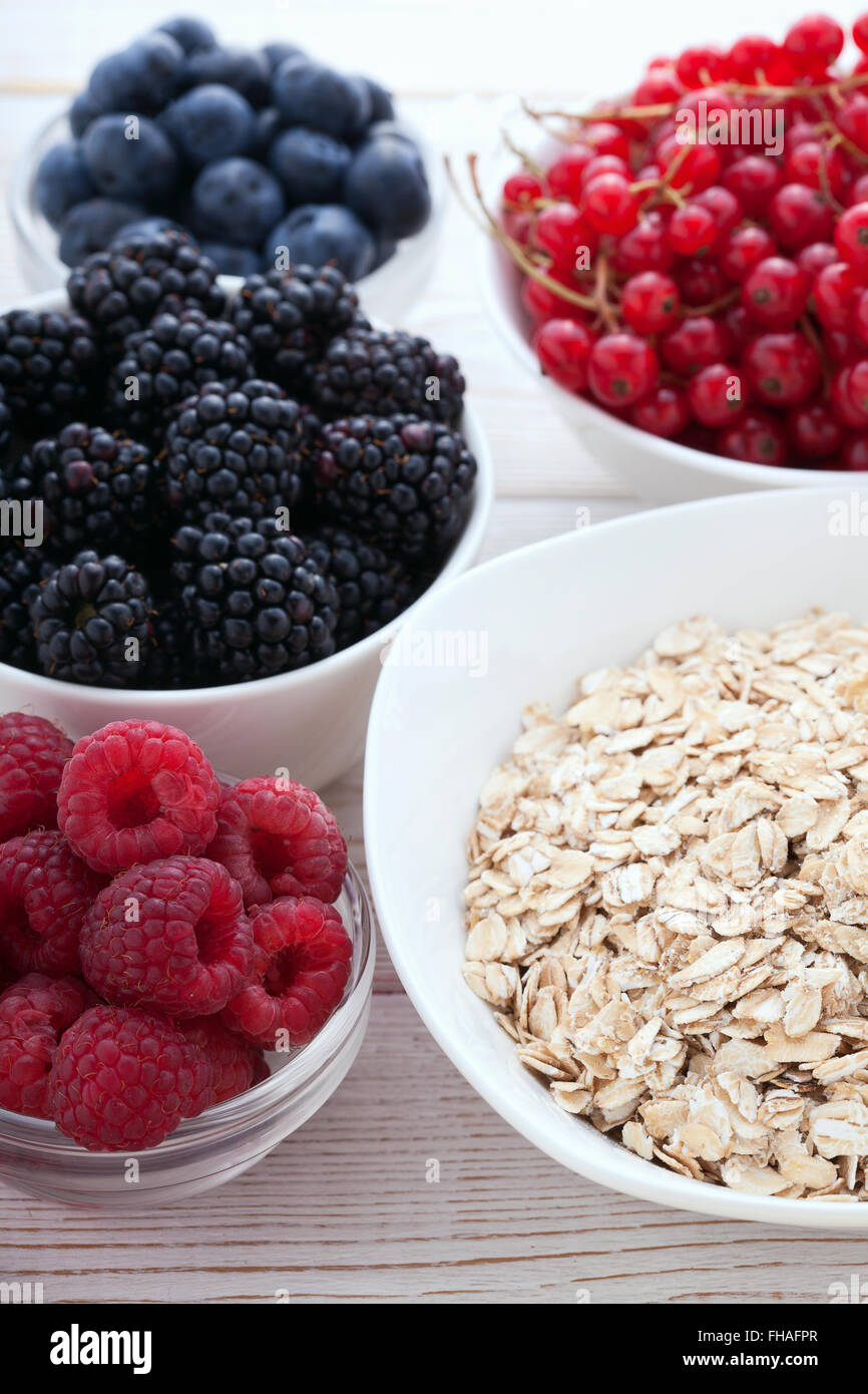 Breakfast - berries, fruit and muesli on white wooden Stock Photo - Alamy