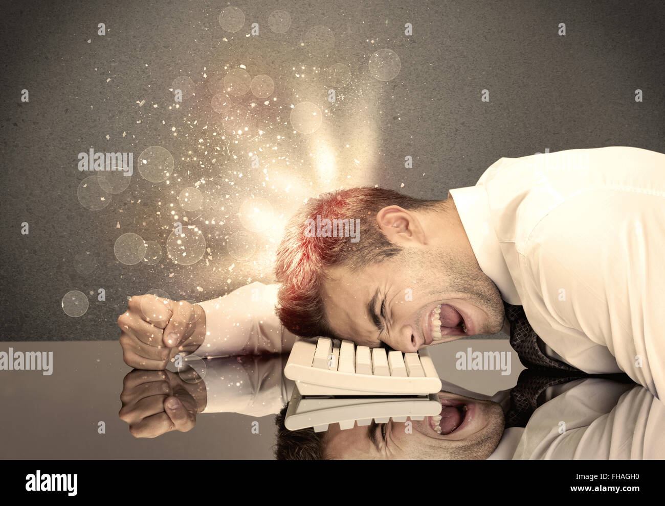 Angry businessman with lights and keyboard Stock Photo - Alamy