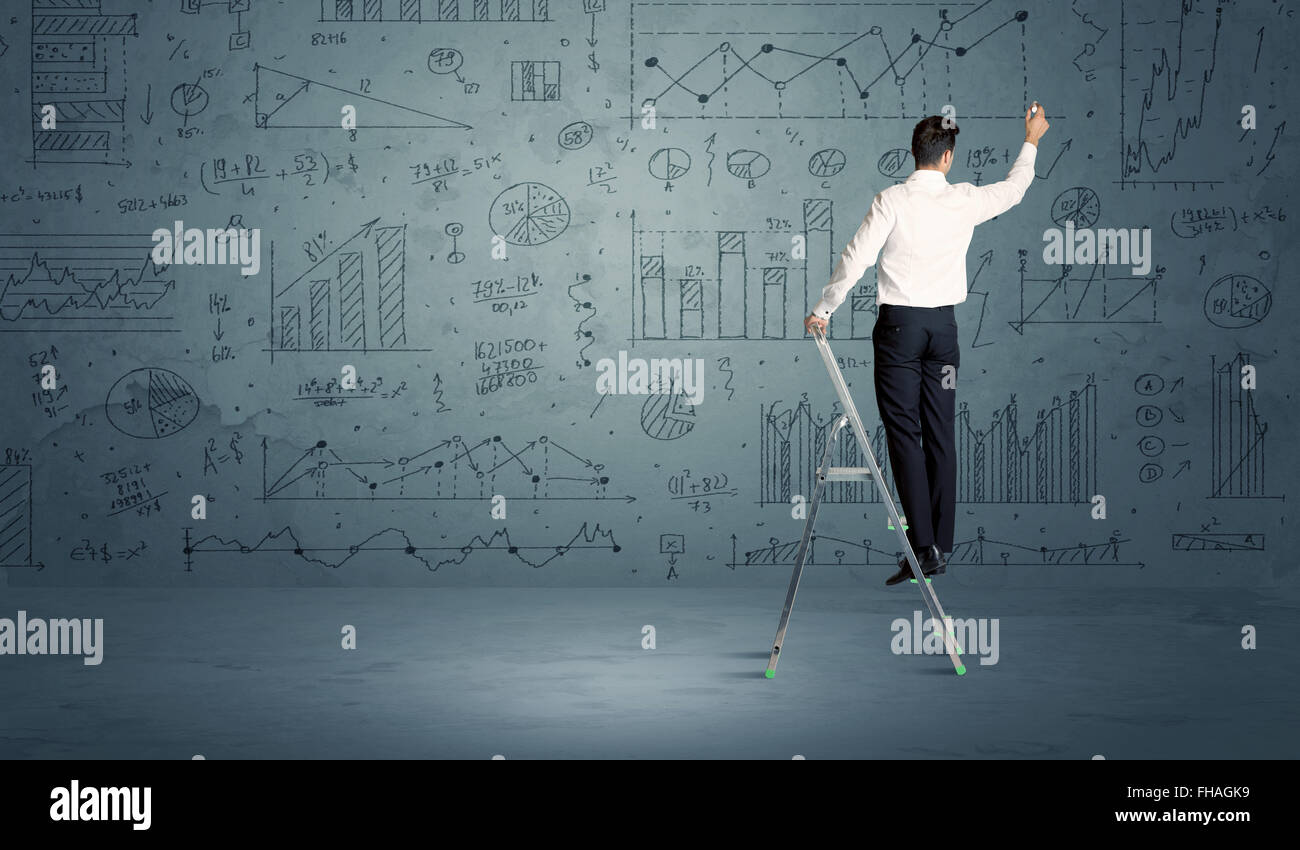 Man on ladder drawing charts Stock Photo - Alamy