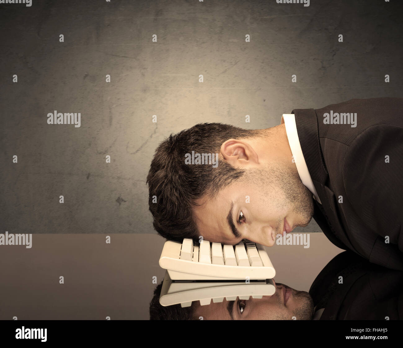 Frustrated businessman's head on keyboard Stock Photo - Alamy