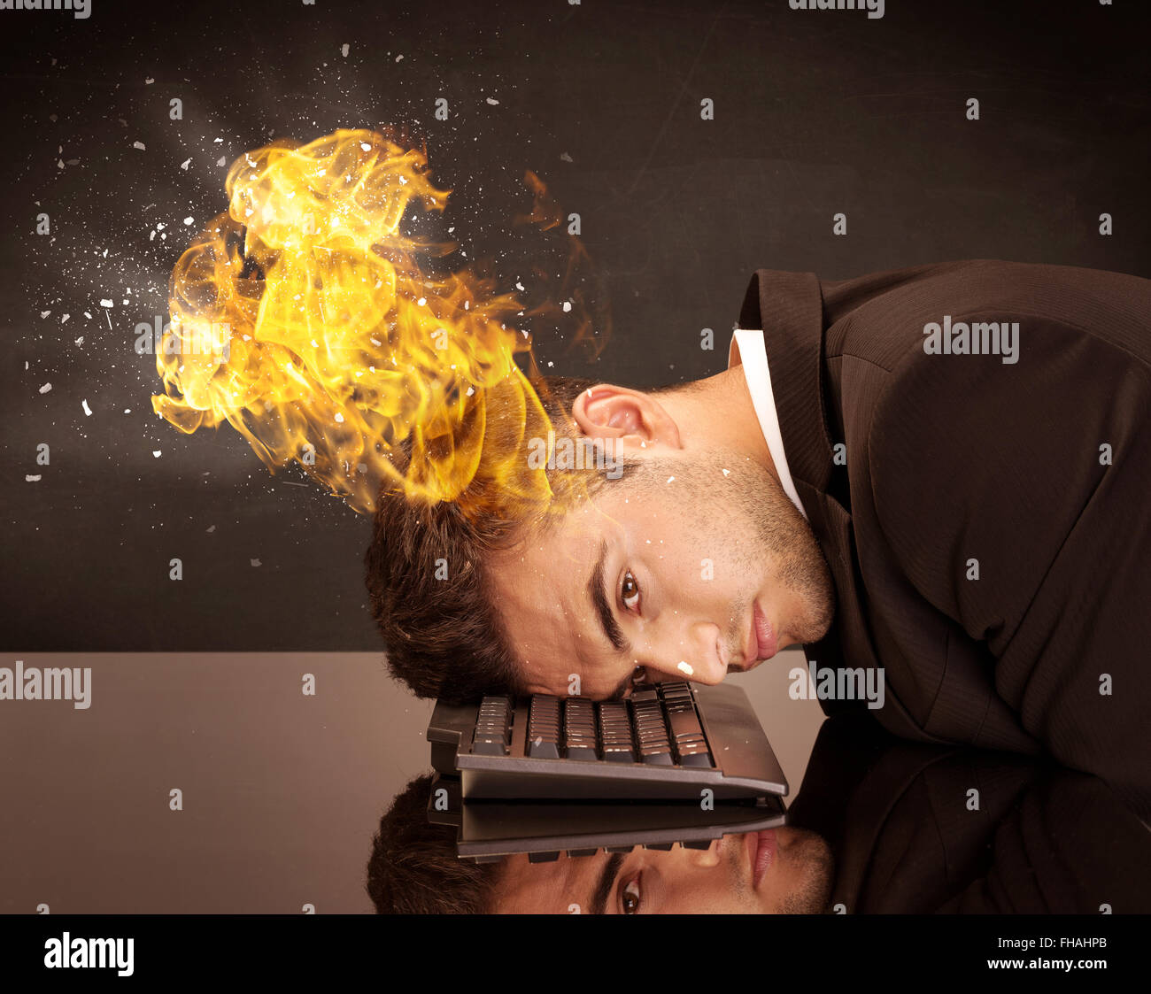Stressed business man's head is burning Stock Photo - Alamy