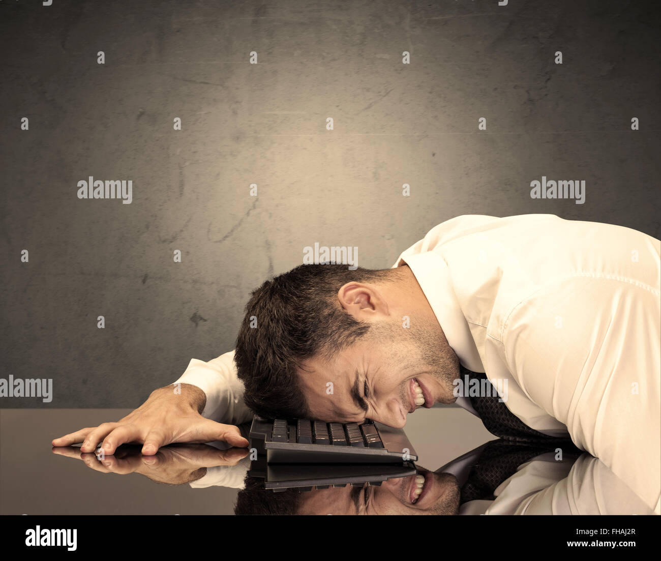 Frustrated businessman's head on keyboard Stock Photo - Alamy