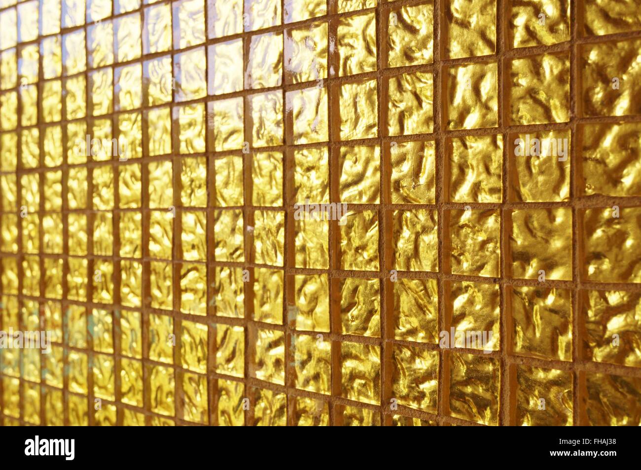 Gold colored square tile mosaic background Stock Photo - Alamy