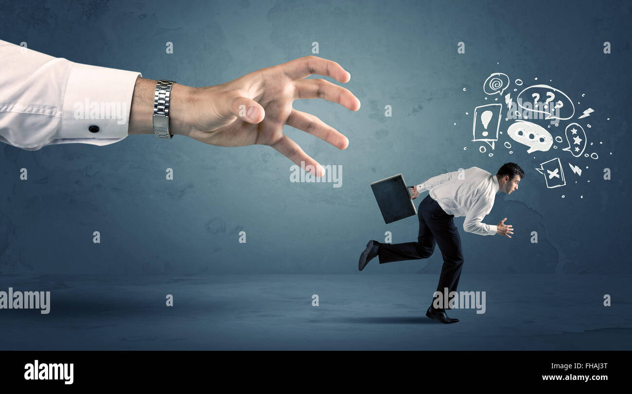 Business man running from a big hand Stock Photo - Alamy