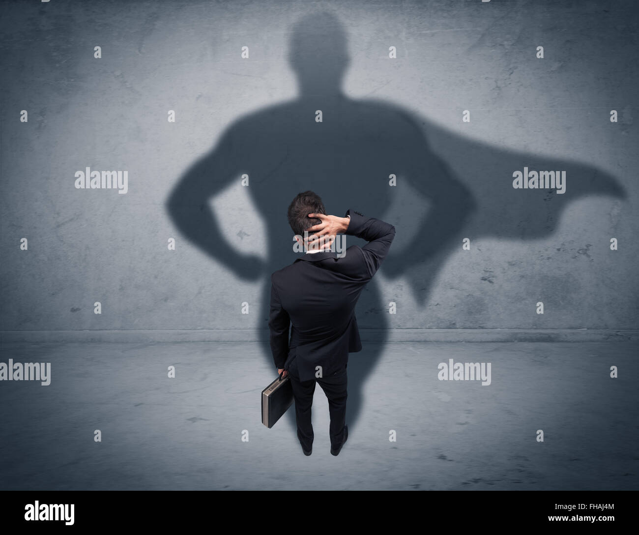 Successful businessman with superhero shadow Stock Photo - Alamy