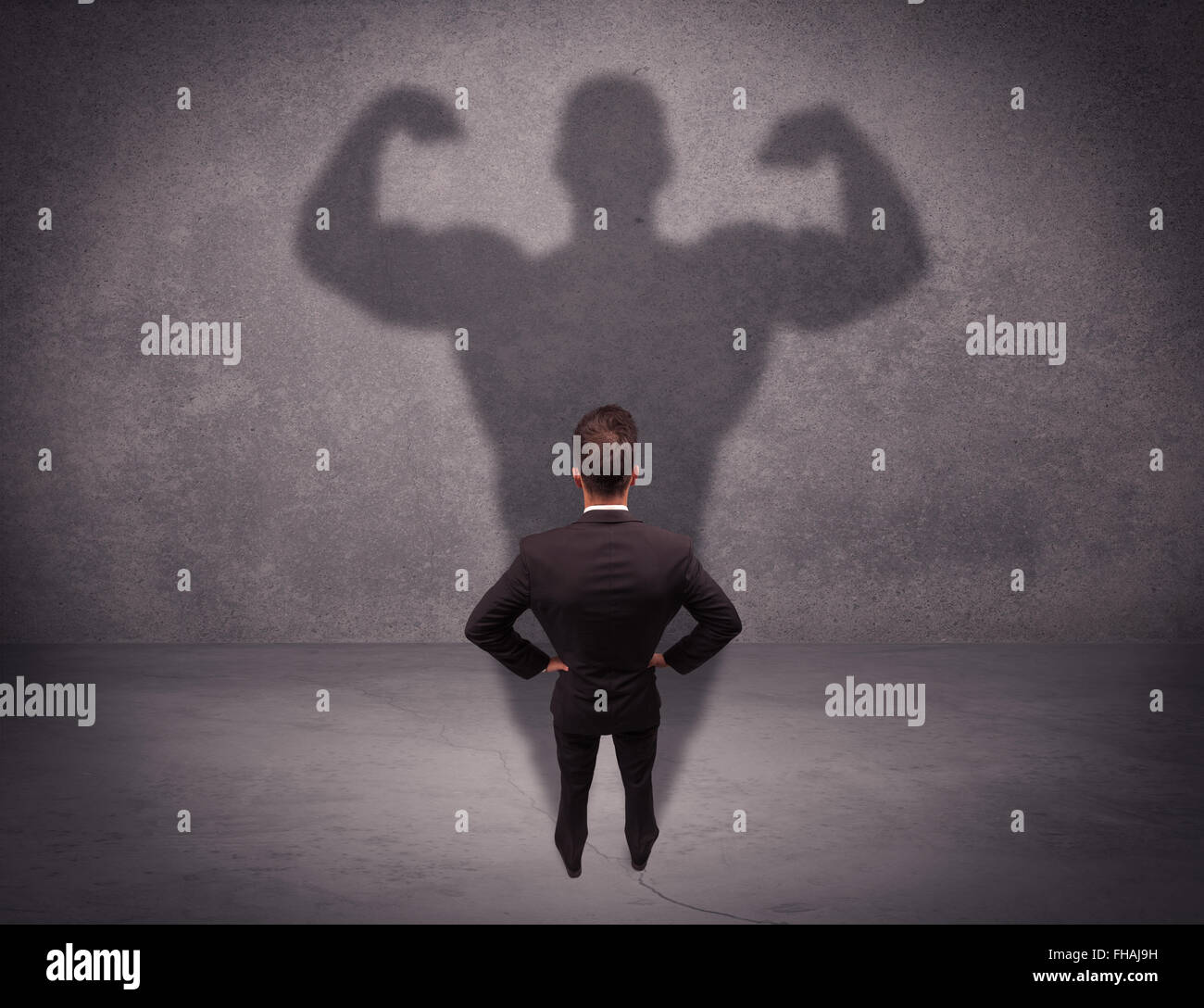 Successful businessman with strong shadow Stock Photo - Alamy