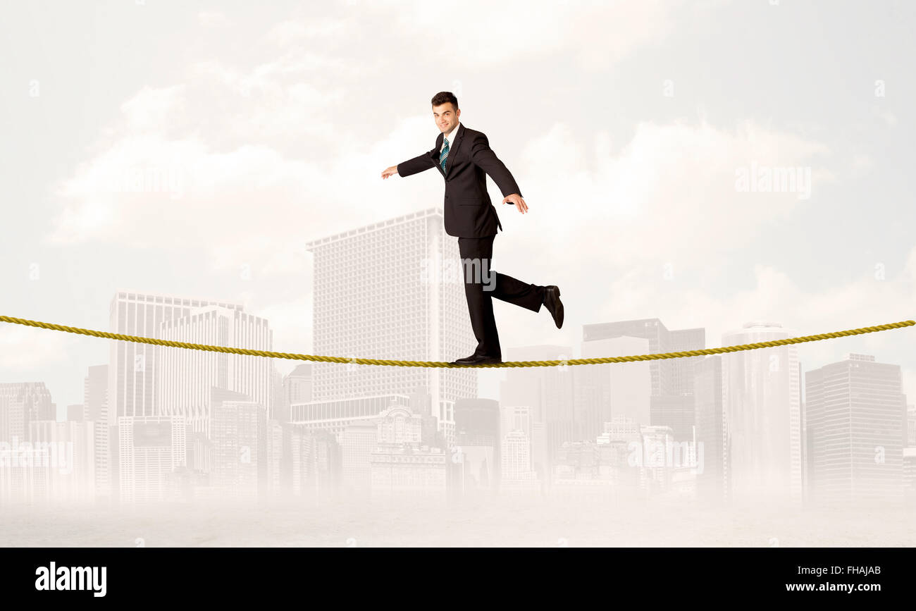 Business person balancing on golden rope Stock Photo - Alamy
