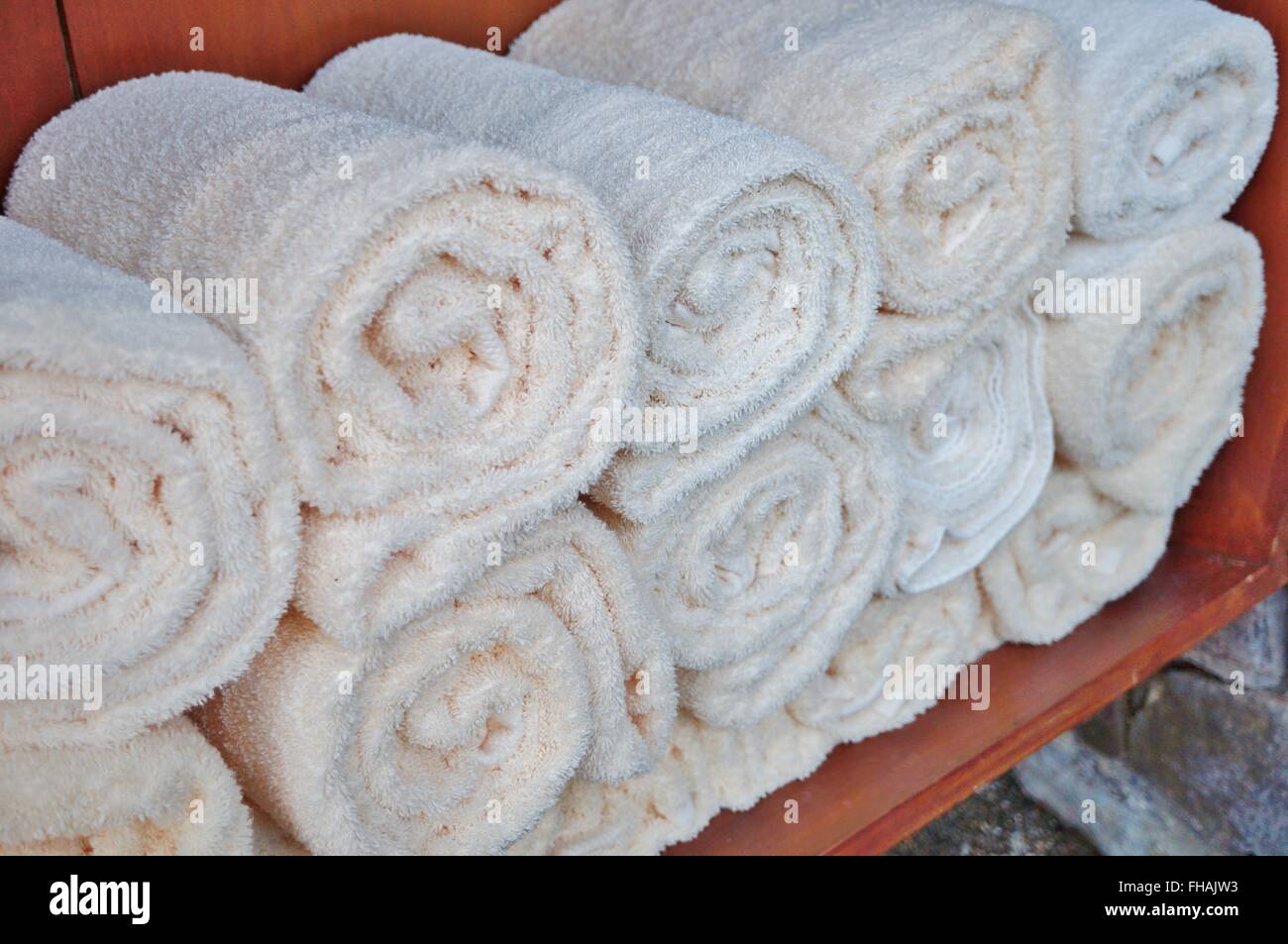 Rolled up white bath towels at the spa Stock Photo - Alamy