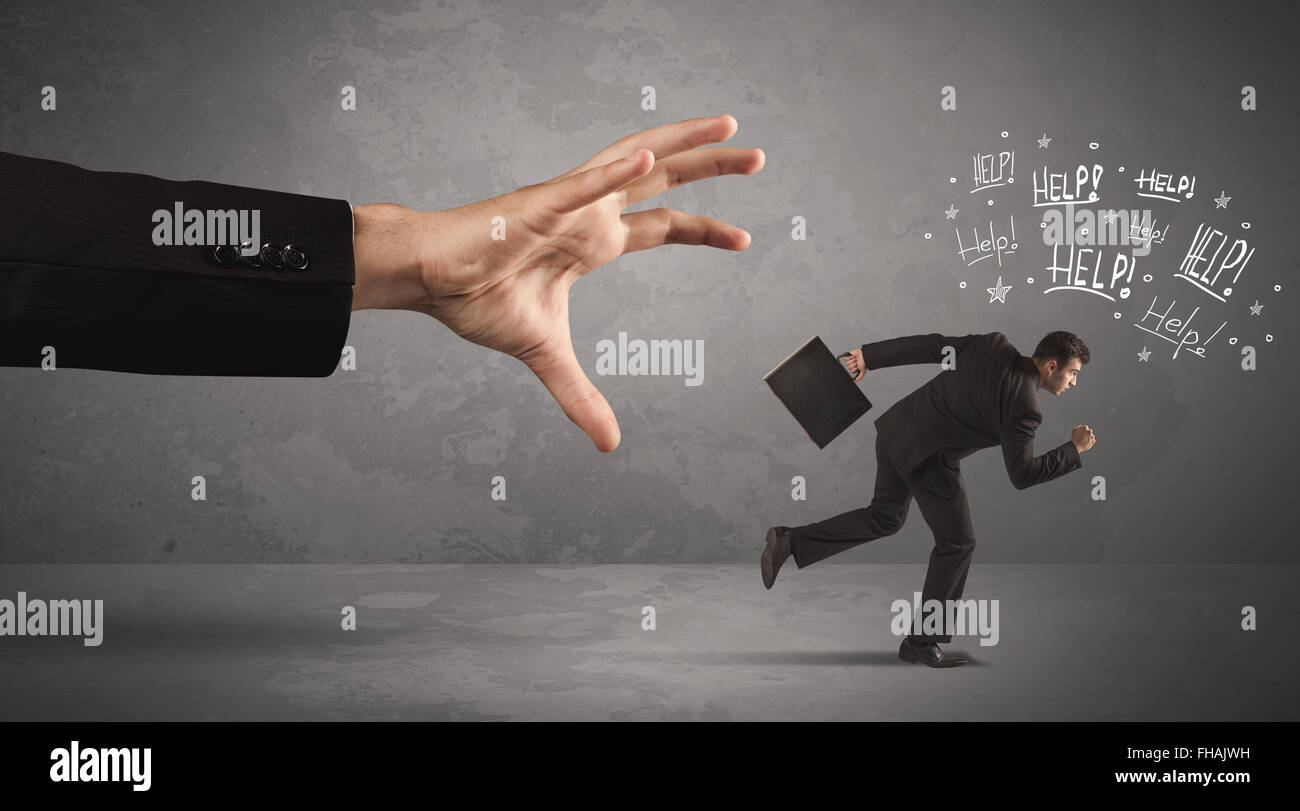Business person running away from big hand Stock Photo - Alamy