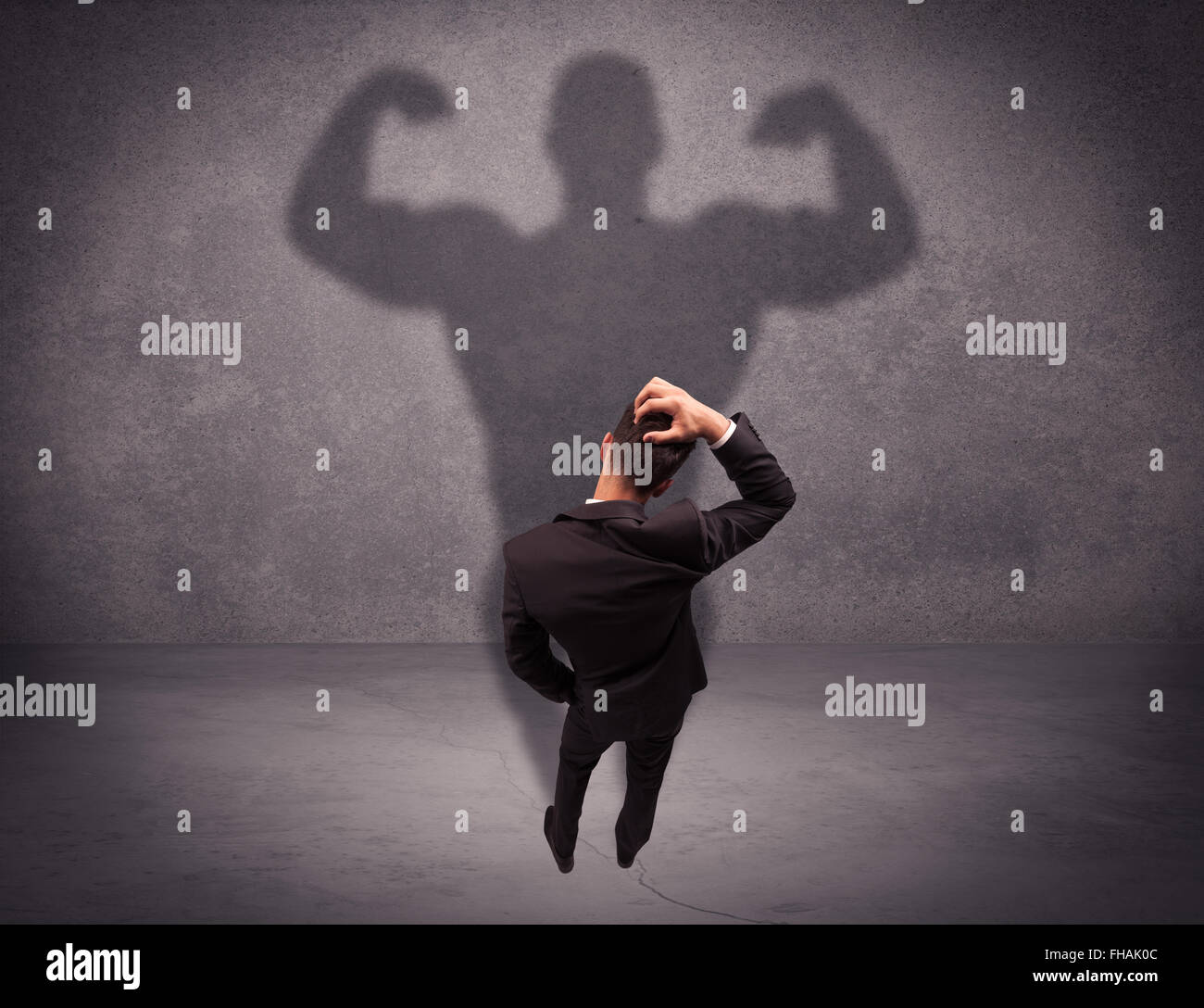 Successful businessman with strong shadow Stock Photo - Alamy
