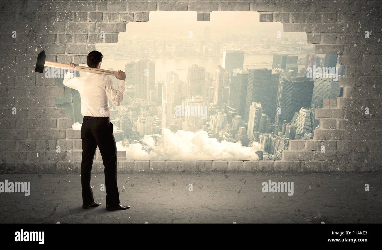 Business man hitting wall with hammer on city view Stock Photo - Alamy