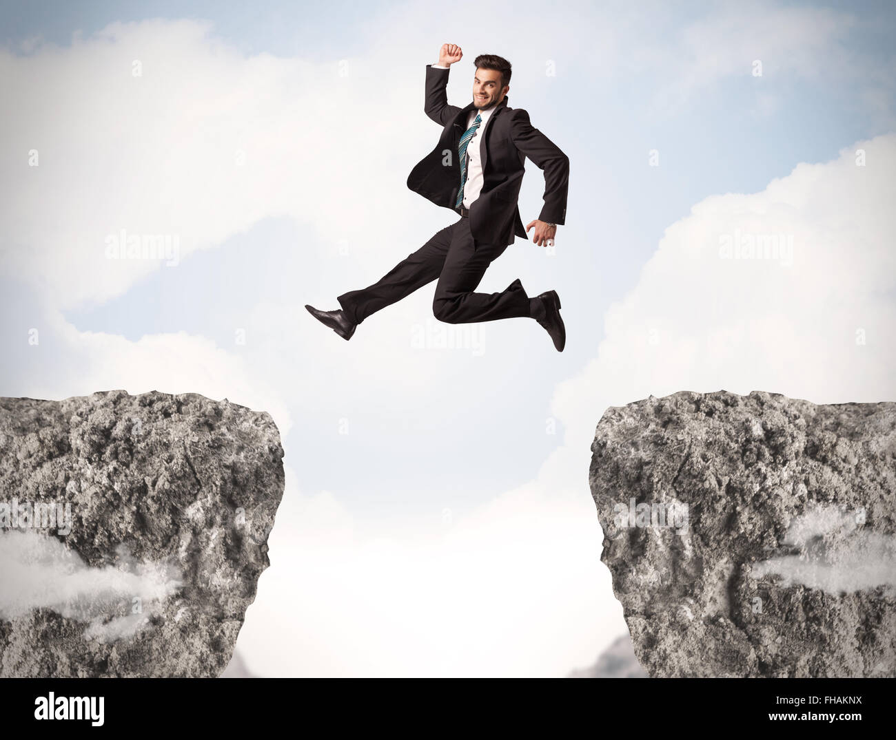 Funny business man jumping over rocks with gap Stock Photo - Alamy