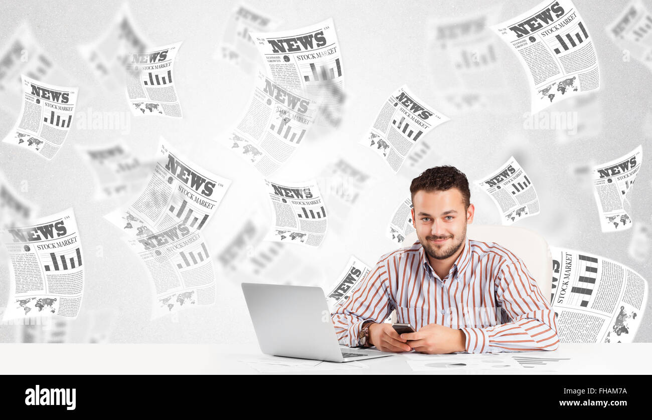 Business man at desk with stock market newspapers Stock Photo - Alamy