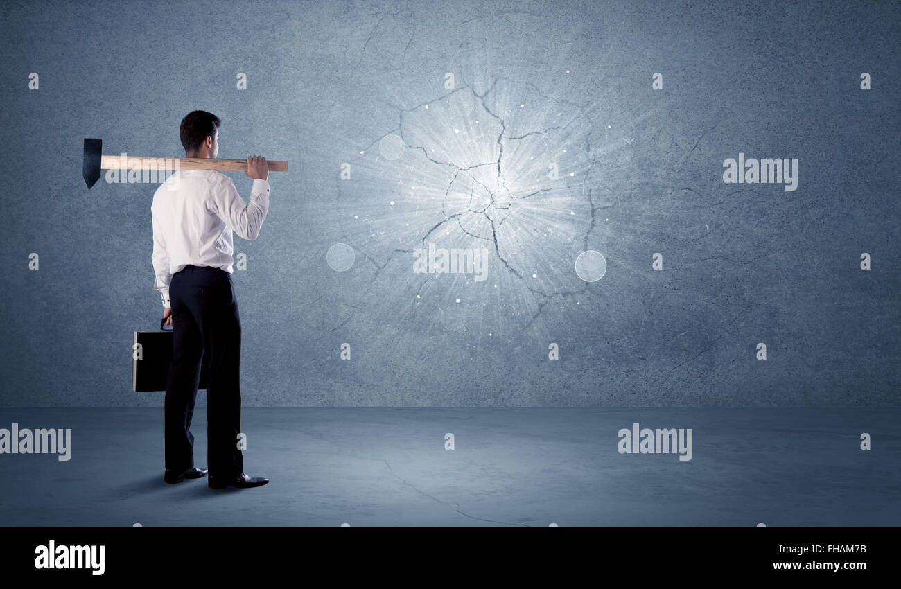 Business man hitting wall with a hammer Stock Photo - Alamy