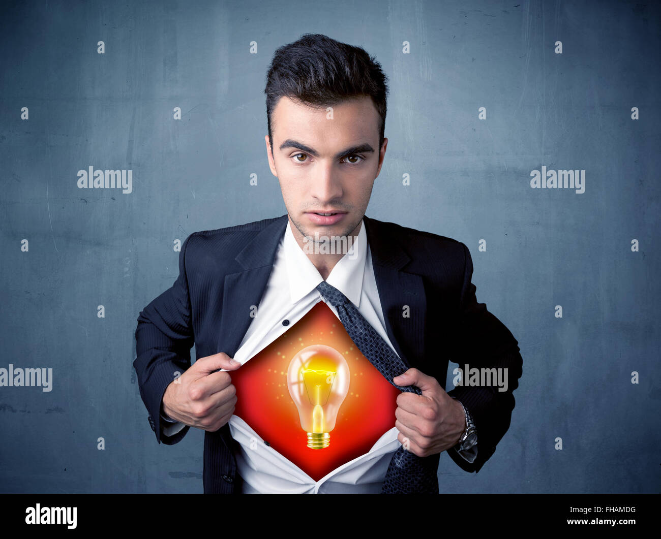 Businessman ripping off shirt and idea light bulb appears Stock Photo ...