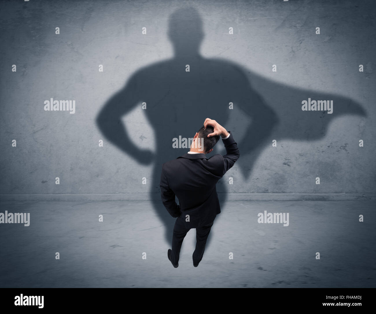 Successful businessman with superhero shadow Stock Photo - Alamy