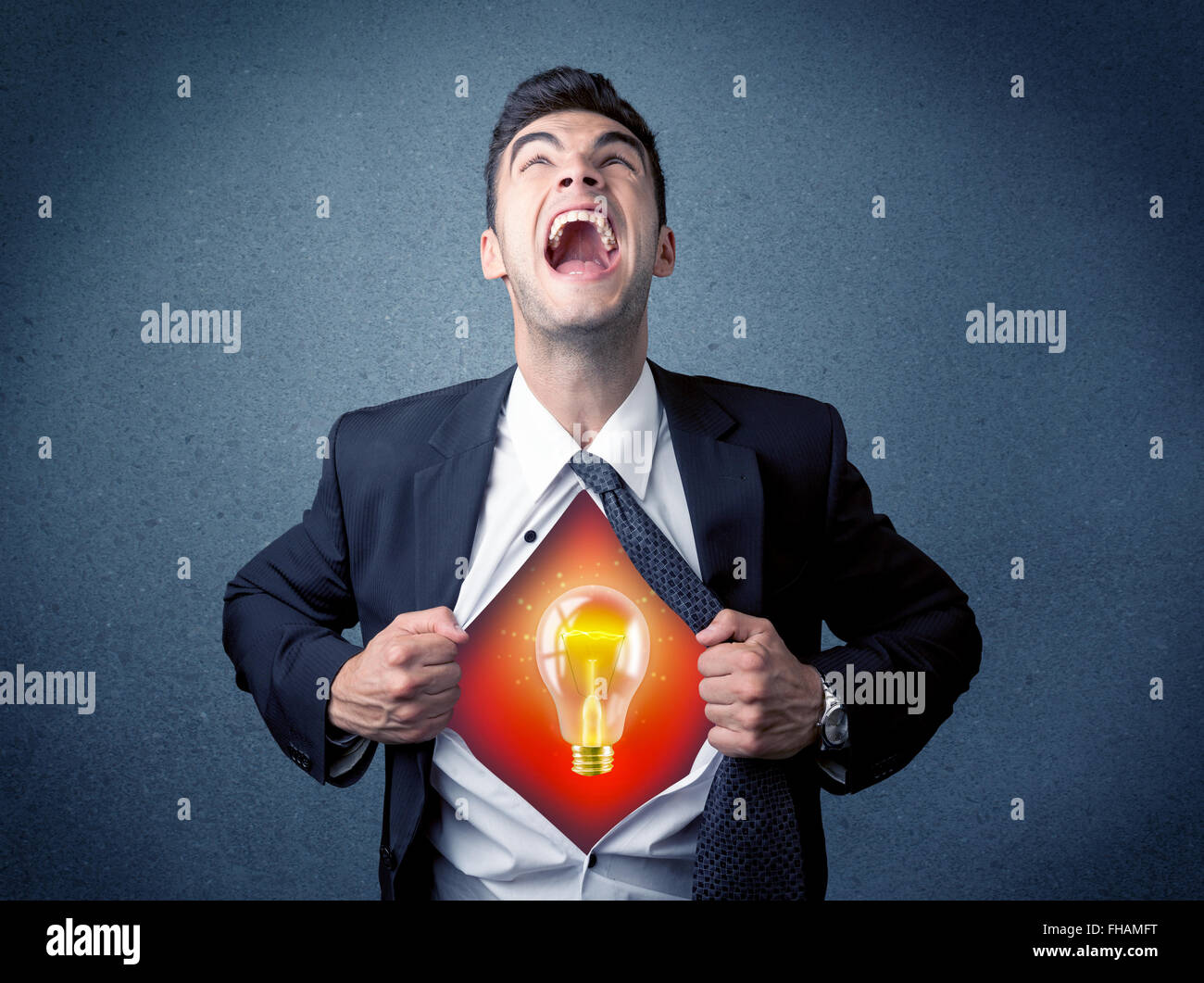 Businessman ripping off shirt and idea light bulb appears Stock Photo ...