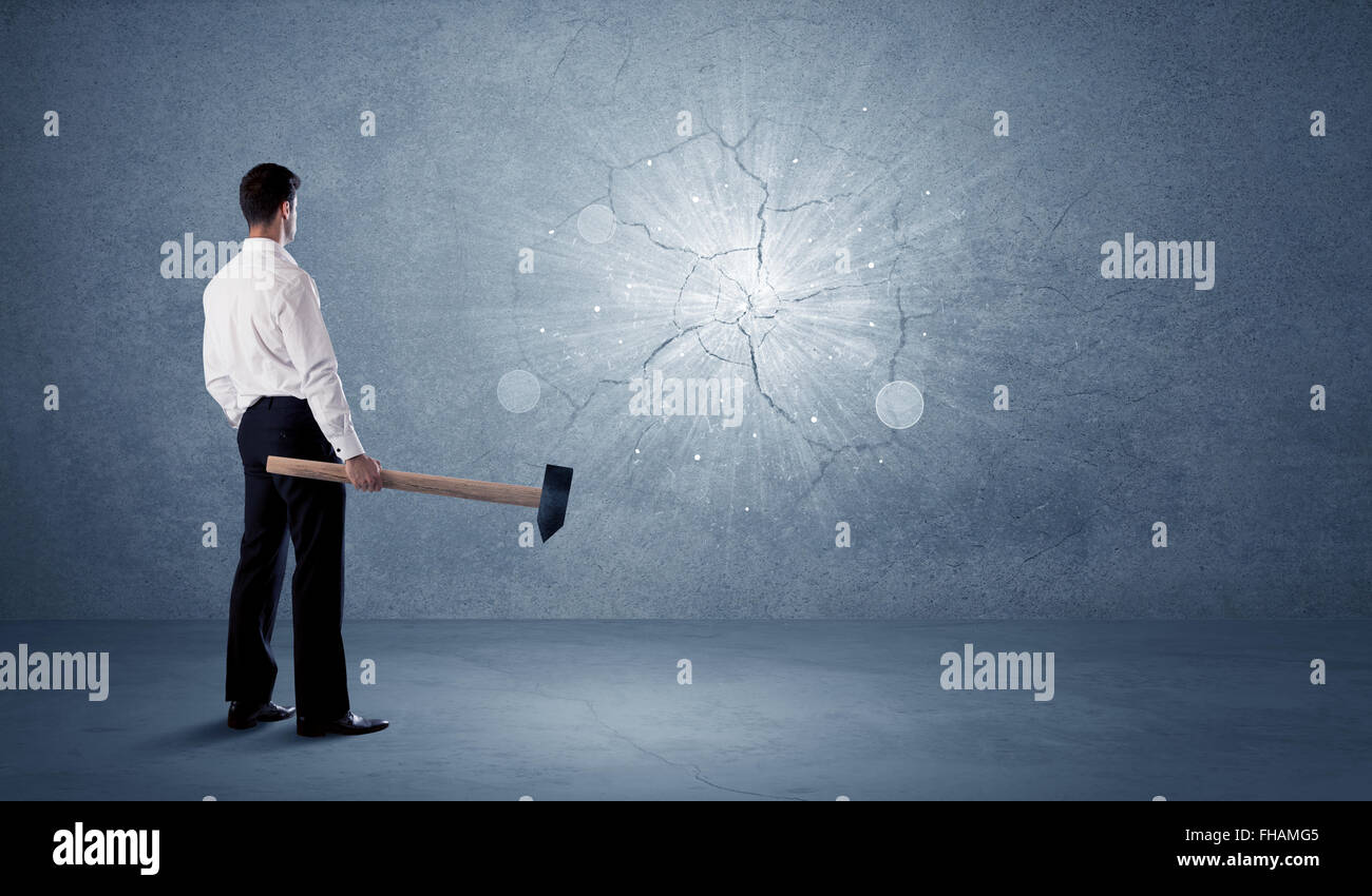 Business man hitting wall with a hammer Stock Photo - Alamy