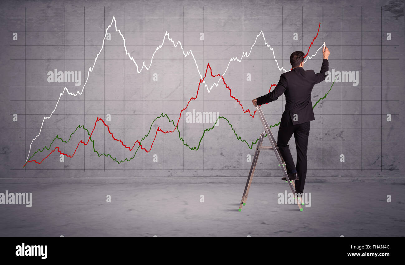 male on ladder drawing chart lines Stock Photo - Alamy