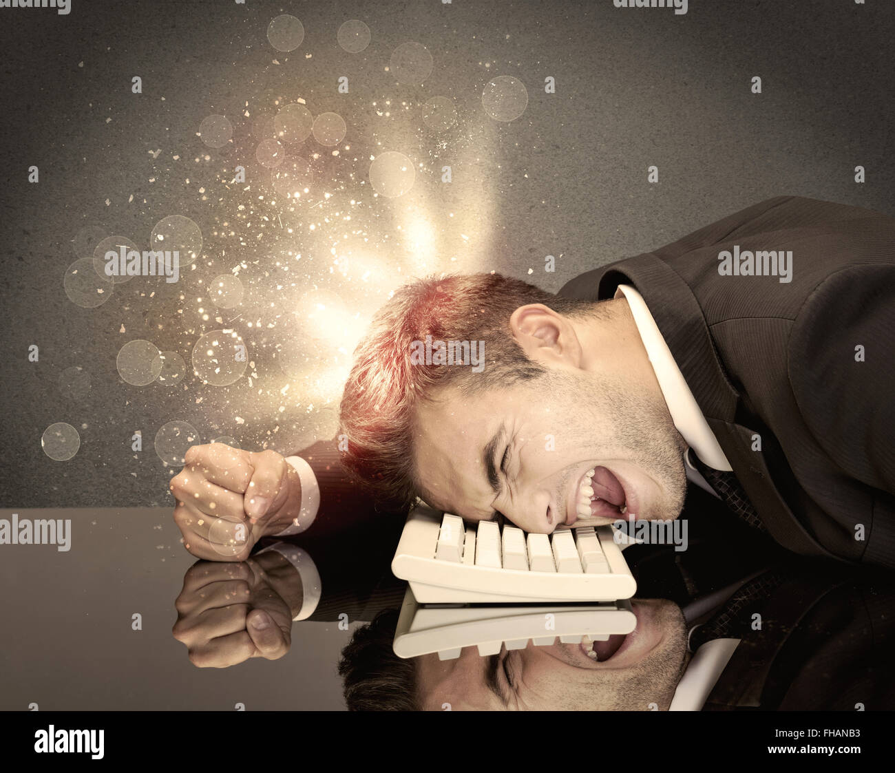 Angry businessman with lights and keyboard Stock Photo - Alamy