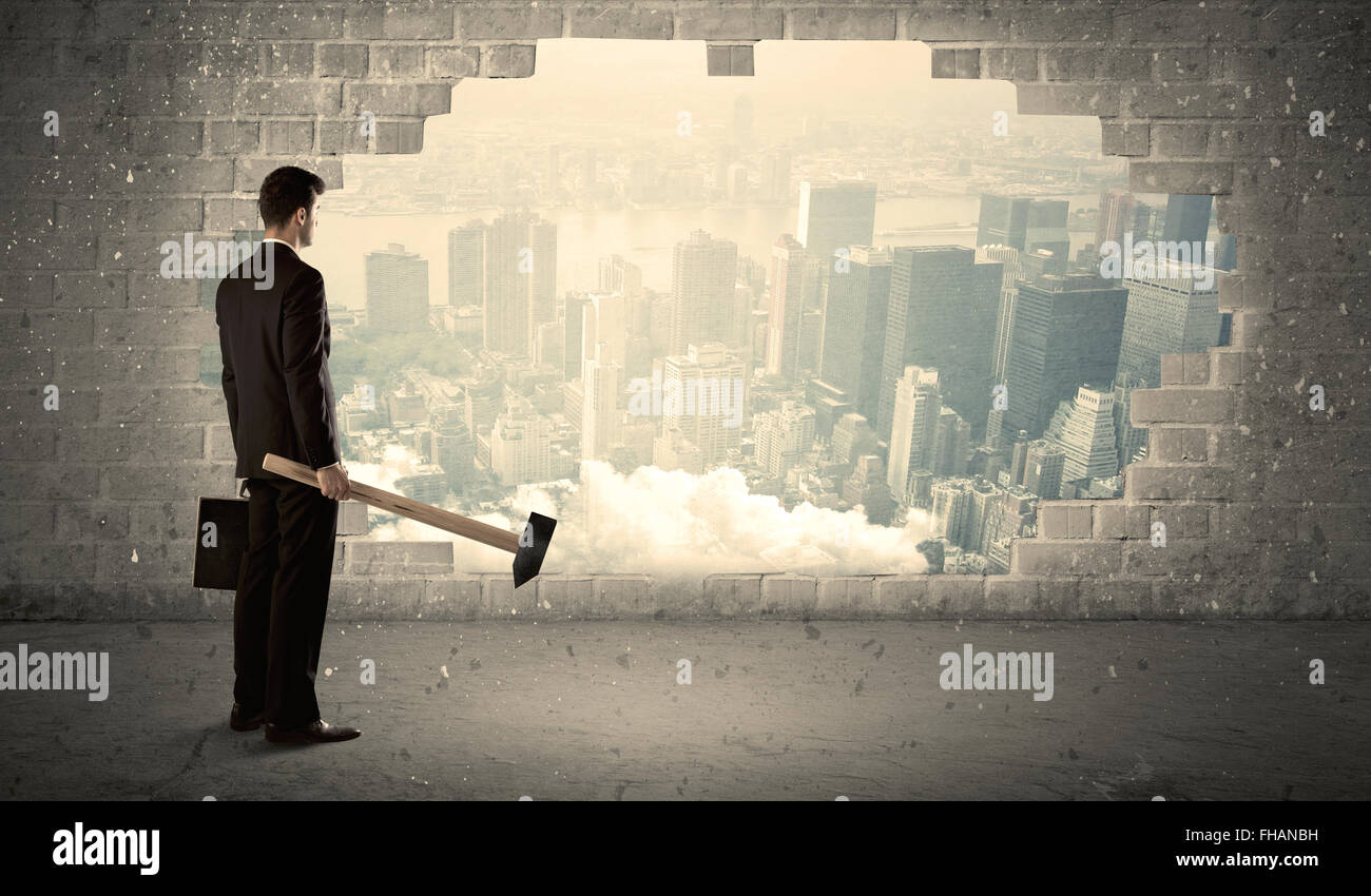 Business man hitting wall with hammer on city view Stock Photo - Alamy