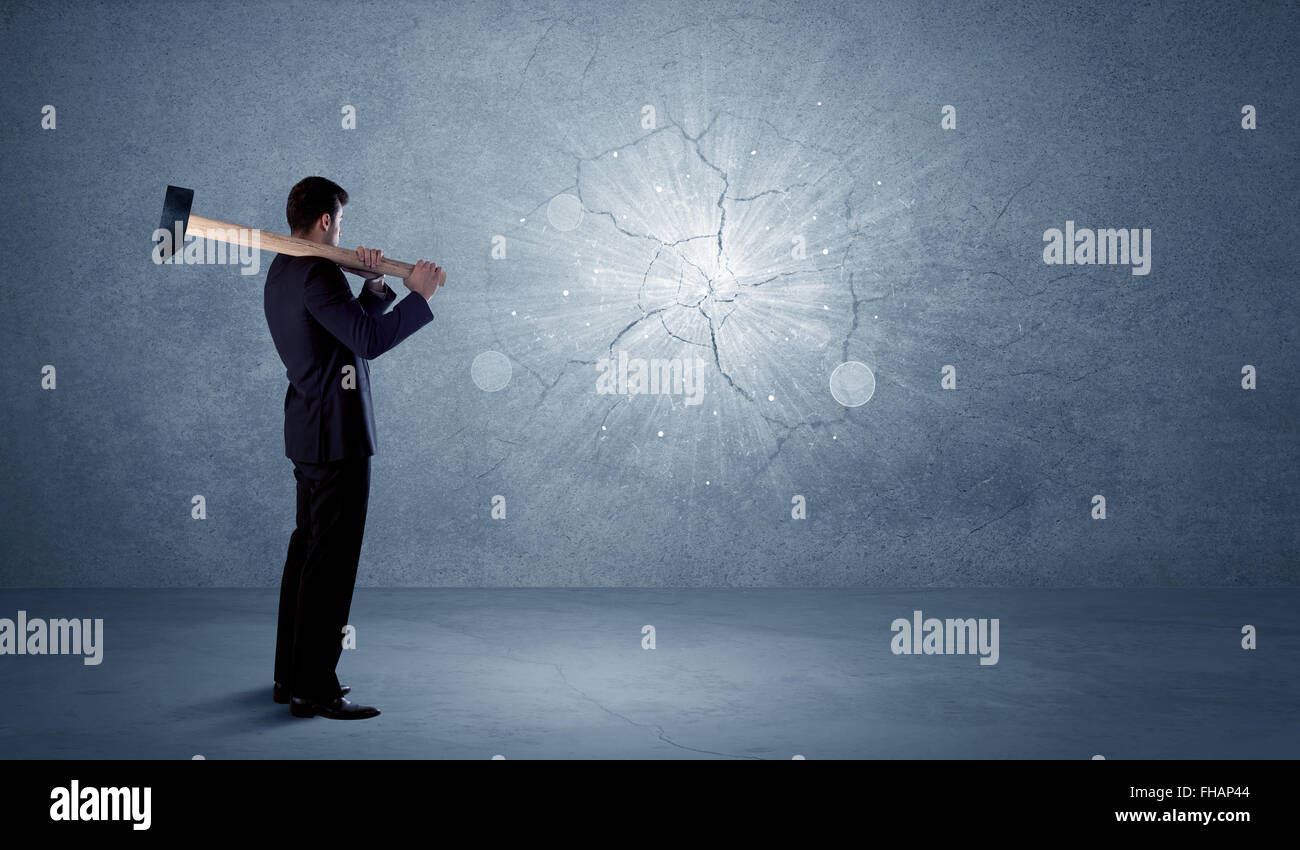 Business man hitting wall with a hammer Stock Photo - Alamy