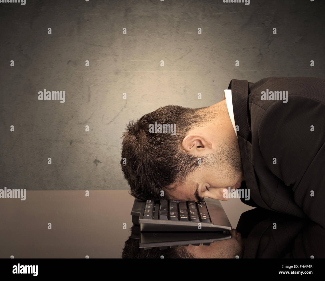 Frustrated businessman's head on keyboard Stock Photo - Alamy