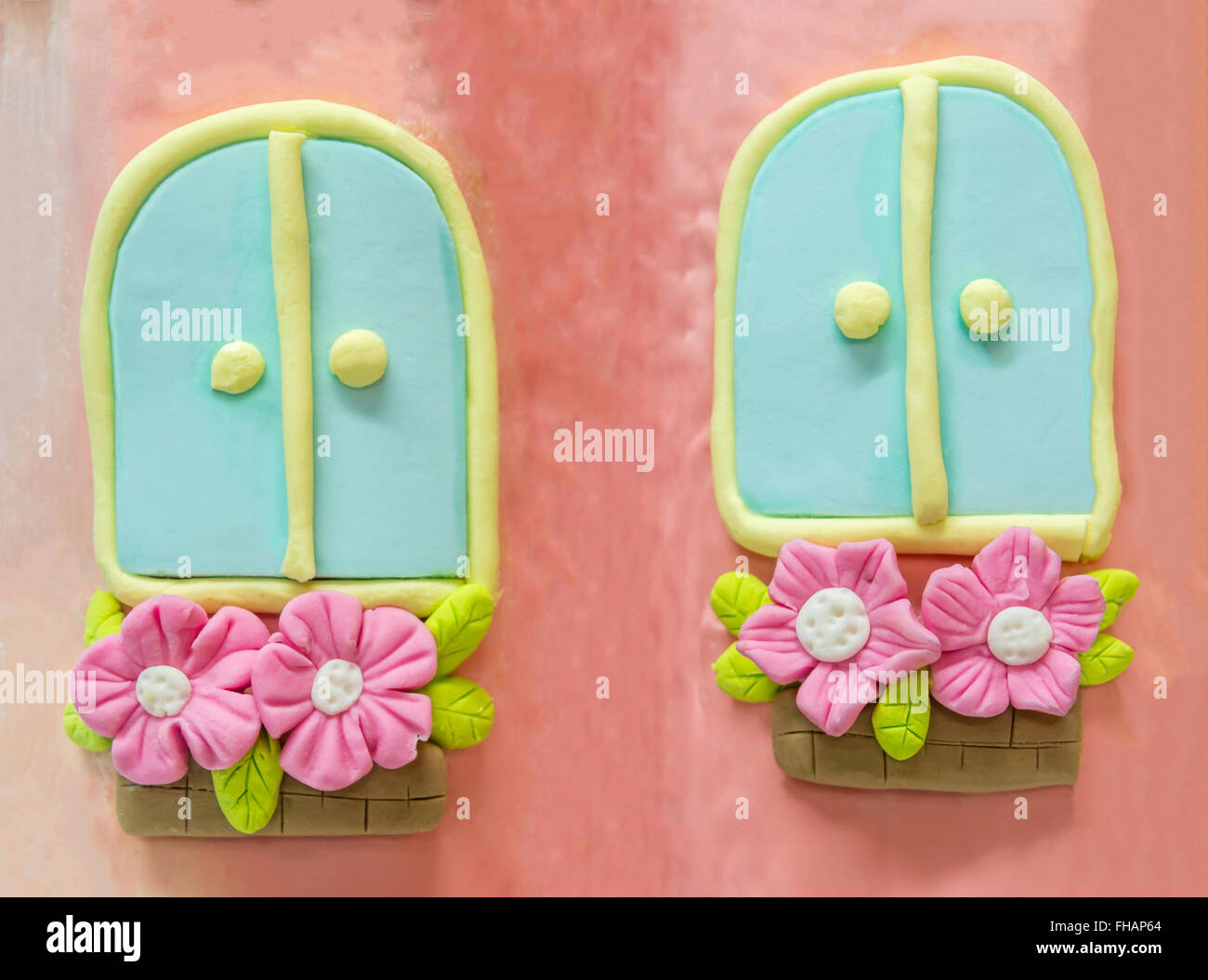 twin sugar windows with pink blossom in pots, stick with pink wall ...