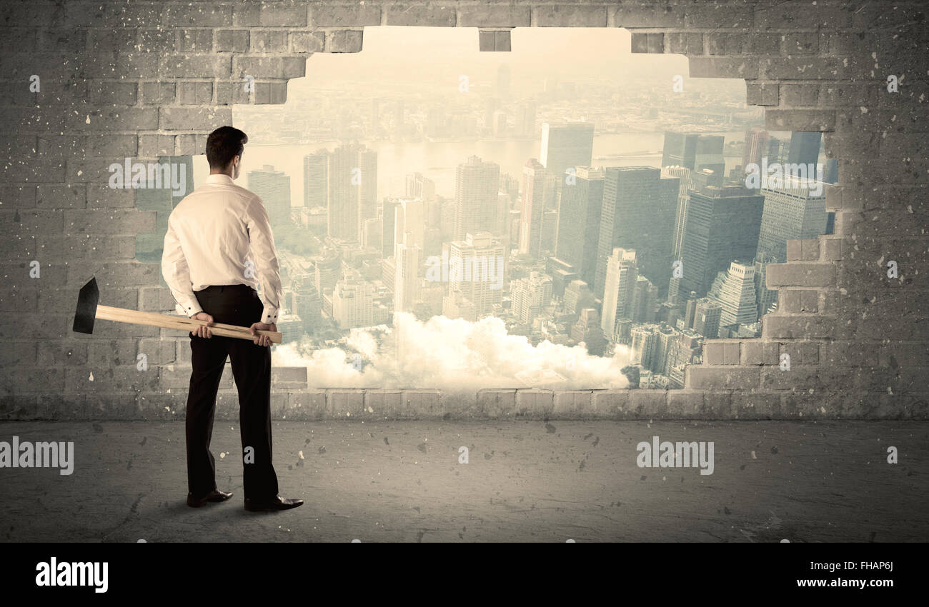 Business man hitting wall with hammer on city view Stock Photo - Alamy