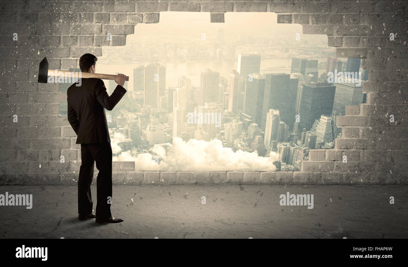 Business man hitting wall with hammer on city view Stock Photo - Alamy