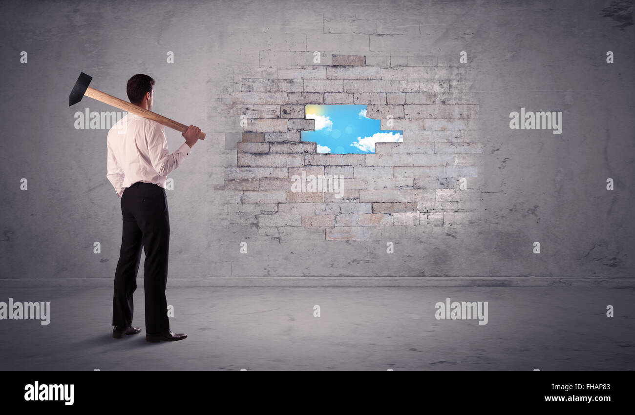 Business man hitting brick wall with hammer Stock Photo - Alamy