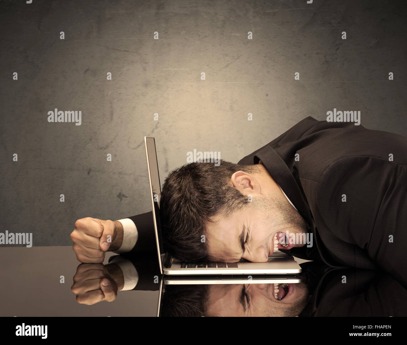 Frustrated businessman's head on keyboard Stock Photo - Alamy