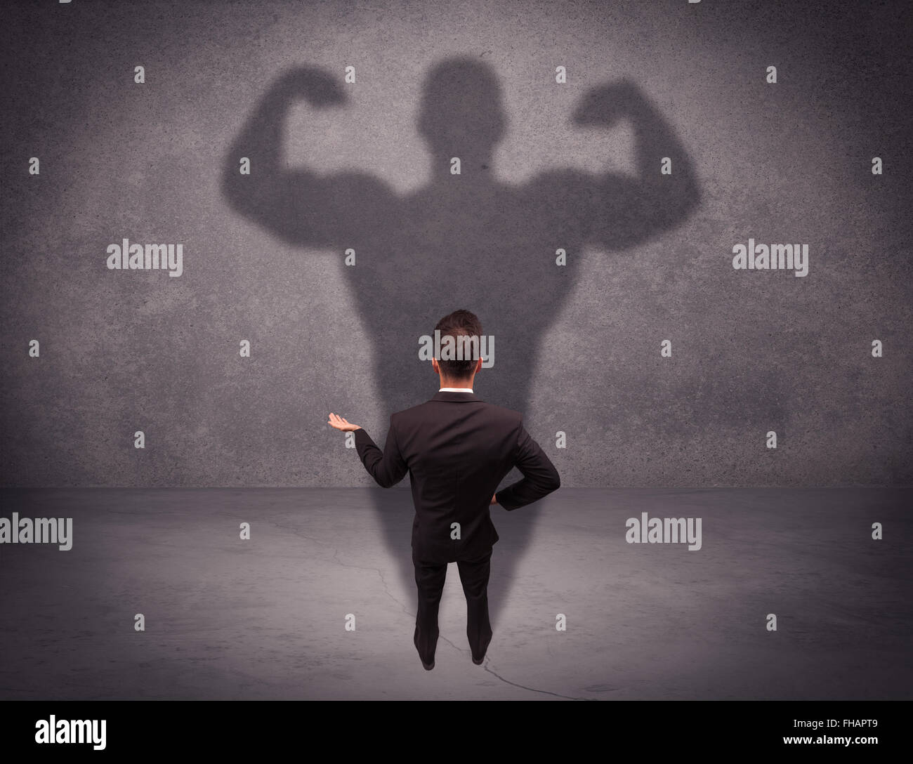 Successful businessman with strong shadow Stock Photo - Alamy