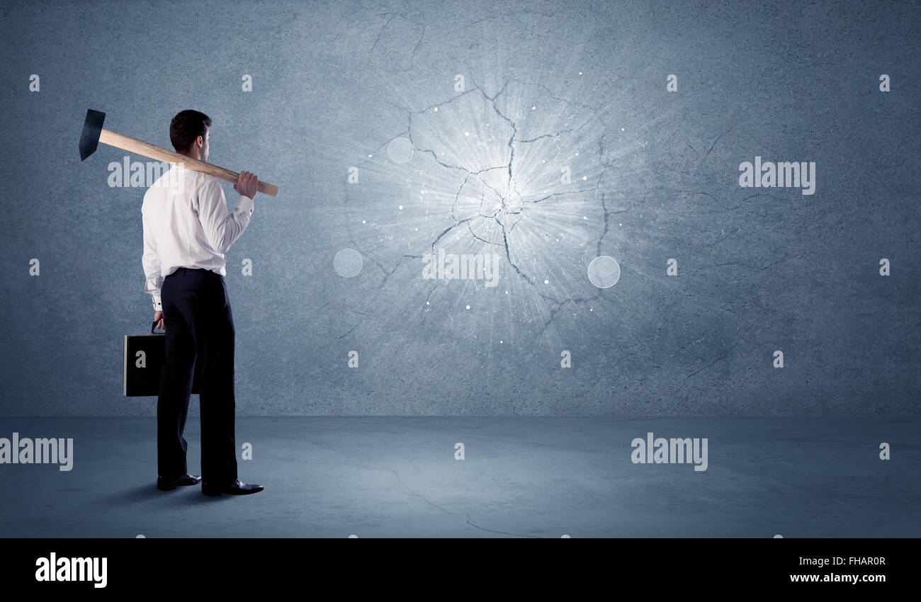 Business man hitting wall with a hammer Stock Photo - Alamy