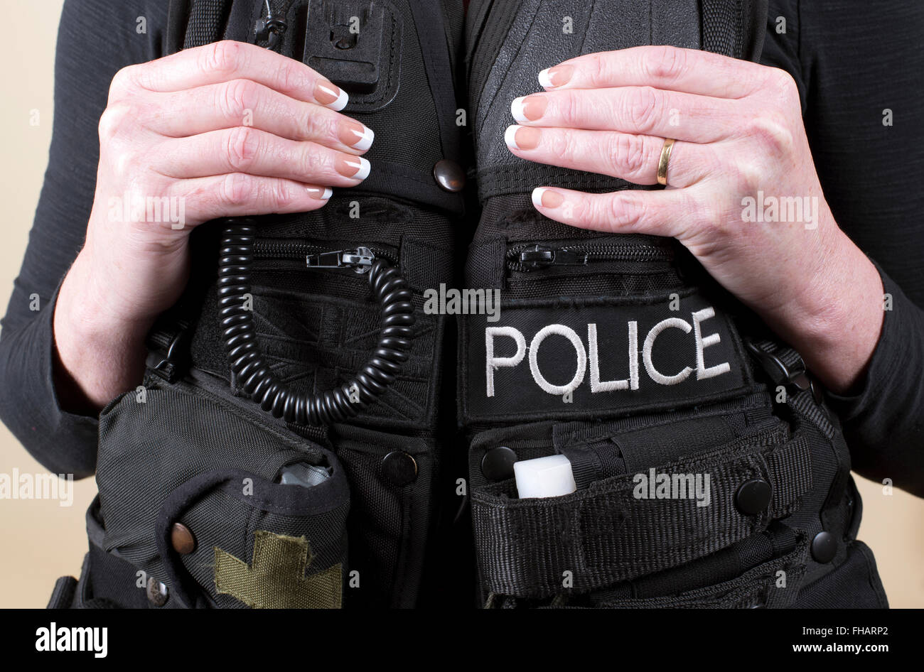 Married female police officer wearing a tactical vest Stock Photo - Alamy