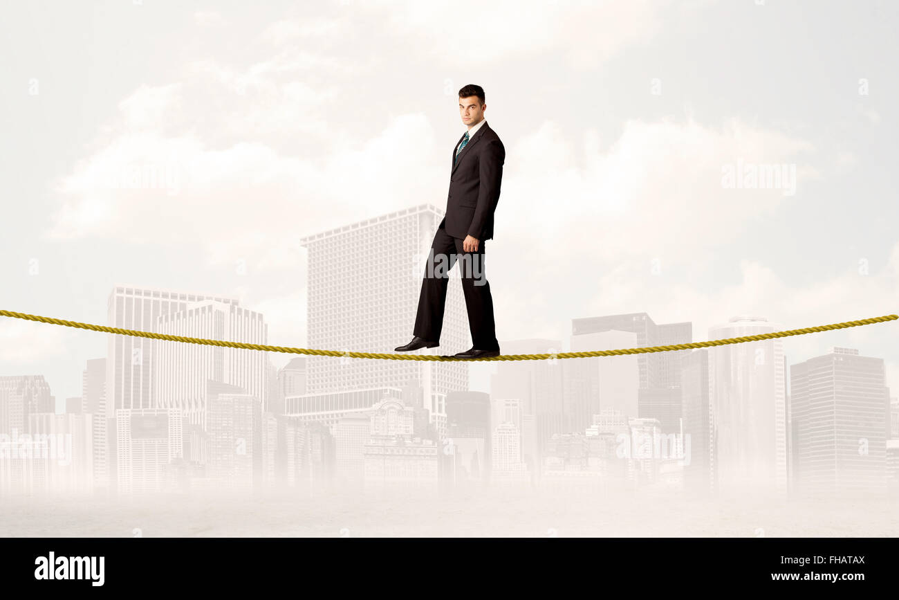Business person balancing on golden rope Stock Photo - Alamy