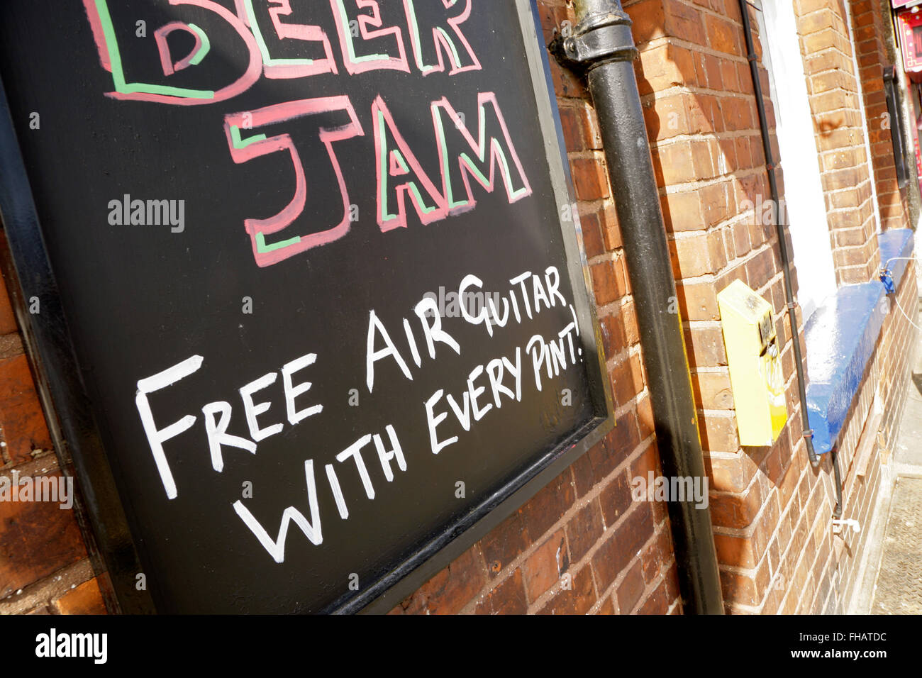 Blackboard outside UK public house offering "free air guitar with every ...