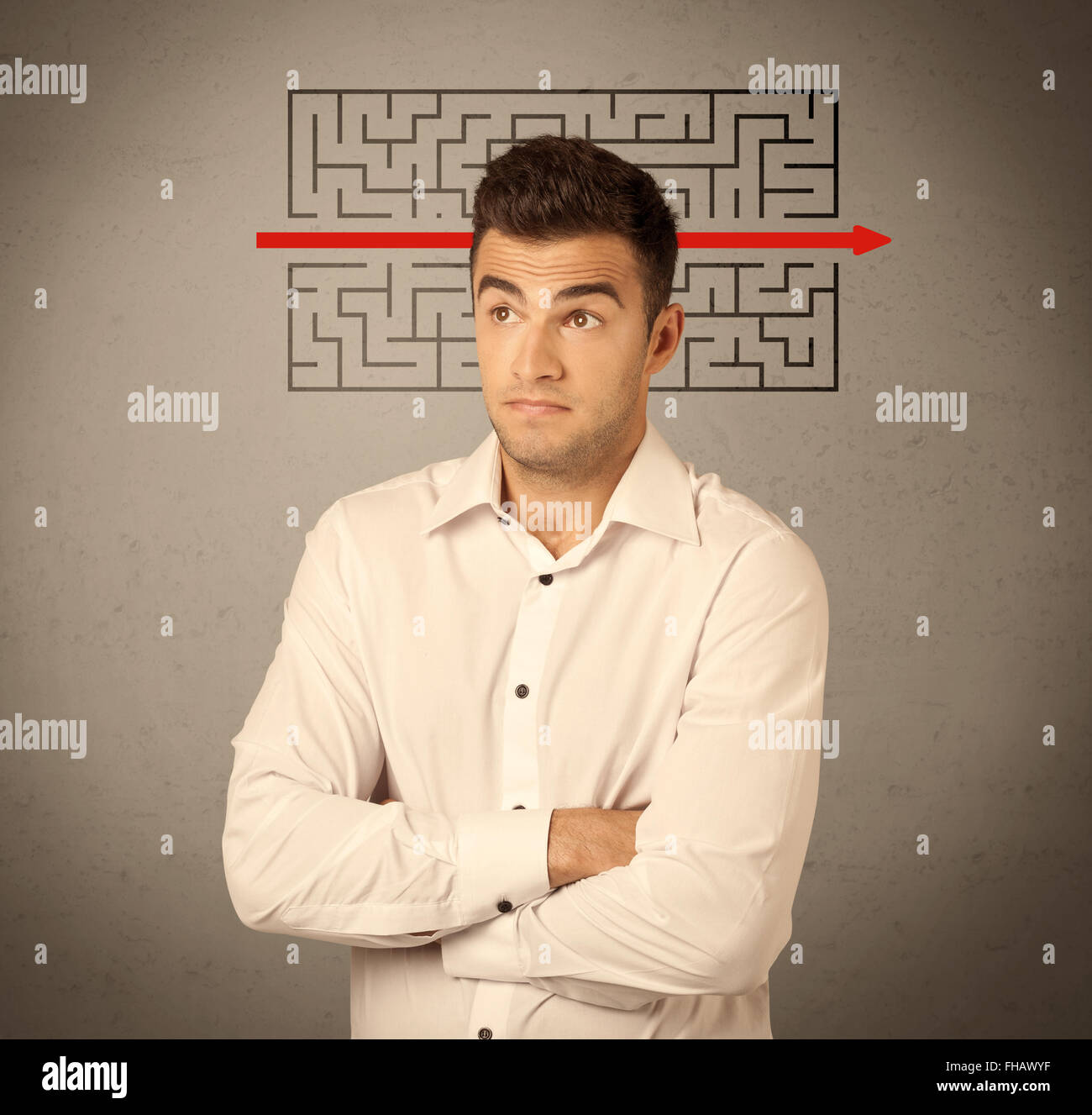 Handsome business guy solving maze Stock Photo - Alamy