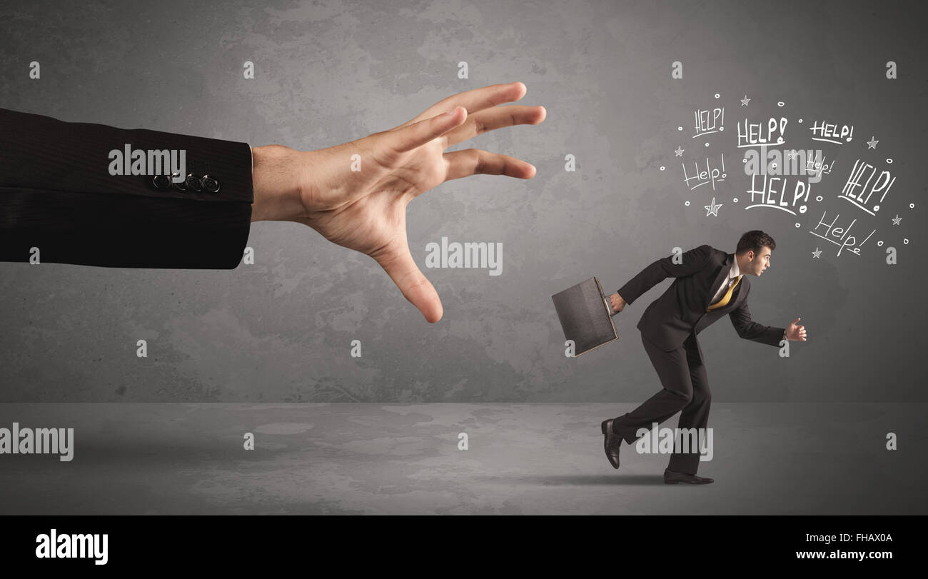 Business person running away from big hand Stock Photo - Alamy