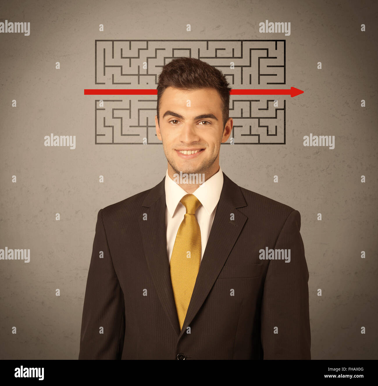 Handsome business guy solving maze Stock Photo - Alamy