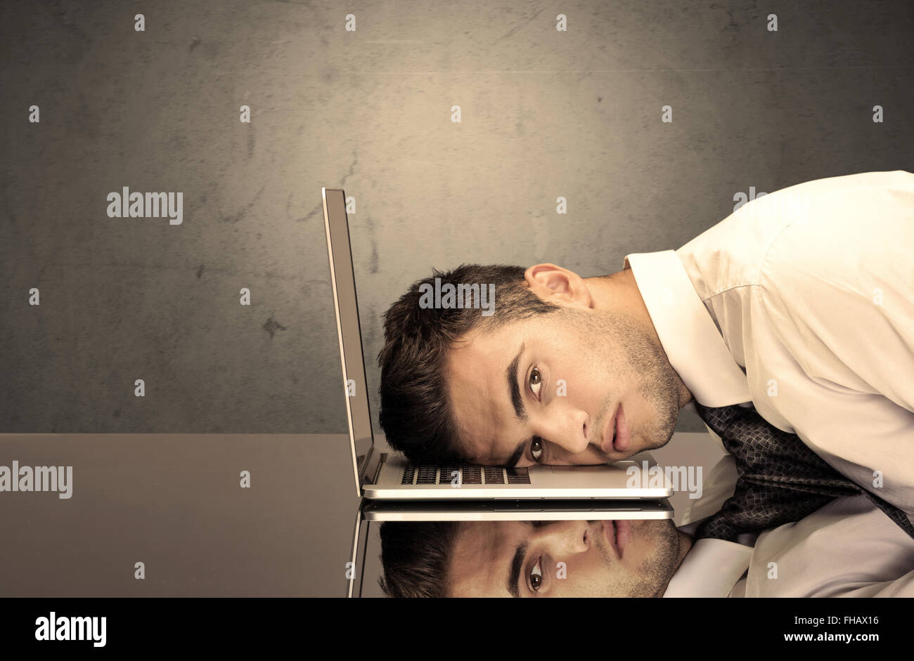 Frustrated businessman's head on keyboard Stock Photo - Alamy