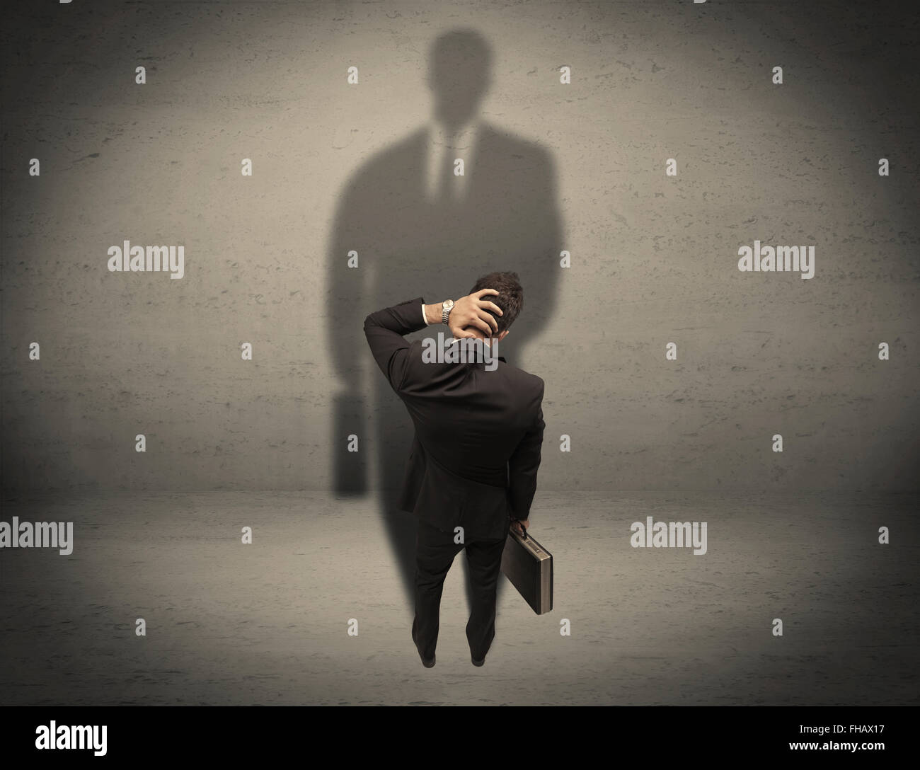 Businessman looking at big shadow concept Stock Photo - Alamy