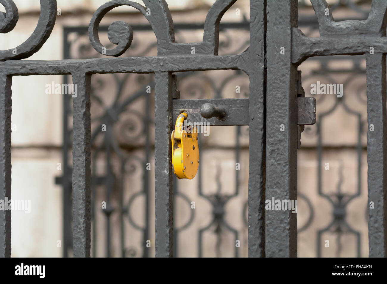 Yellow padlock on gate Stock Photo - Alamy