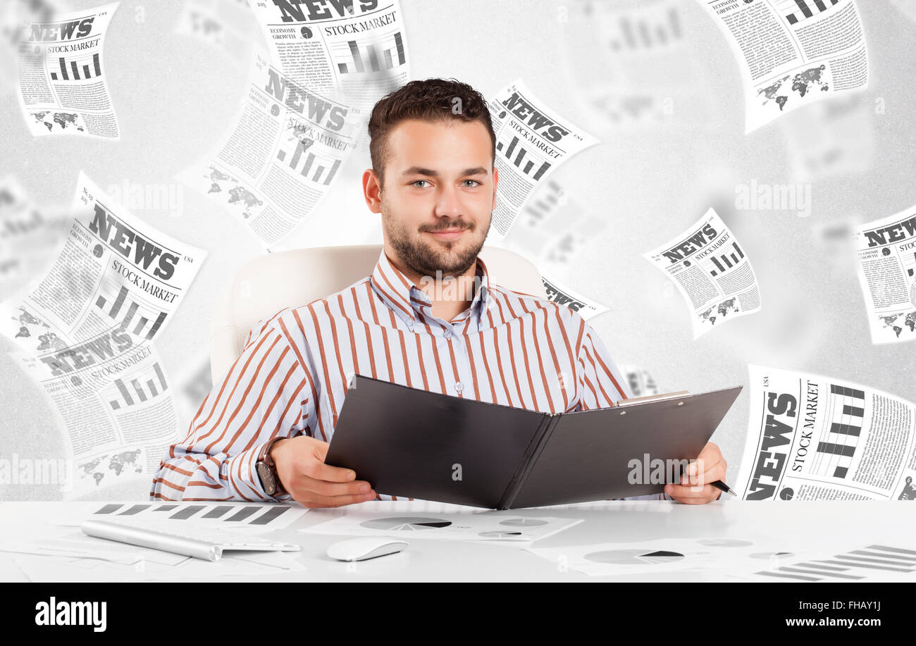 Business man at desk with stock market newspapers Stock Photo - Alamy