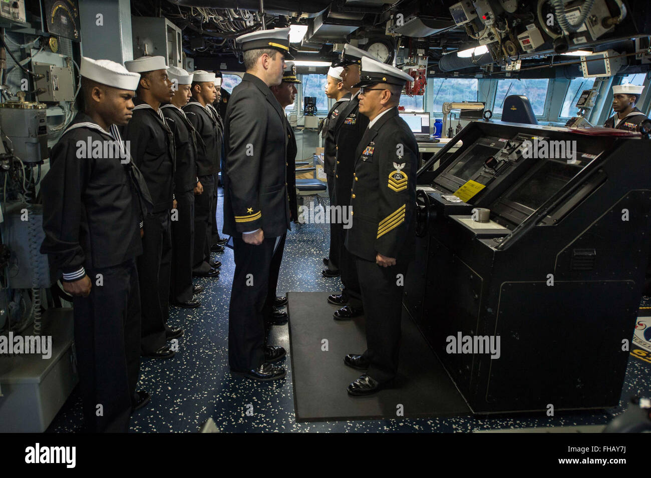 A photograph documenting the inspection of U.S. Navy personnel wearing ...