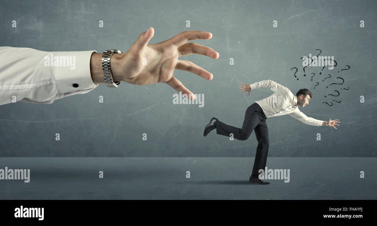 Businessman running away from a big hand Stock Photo - Alamy