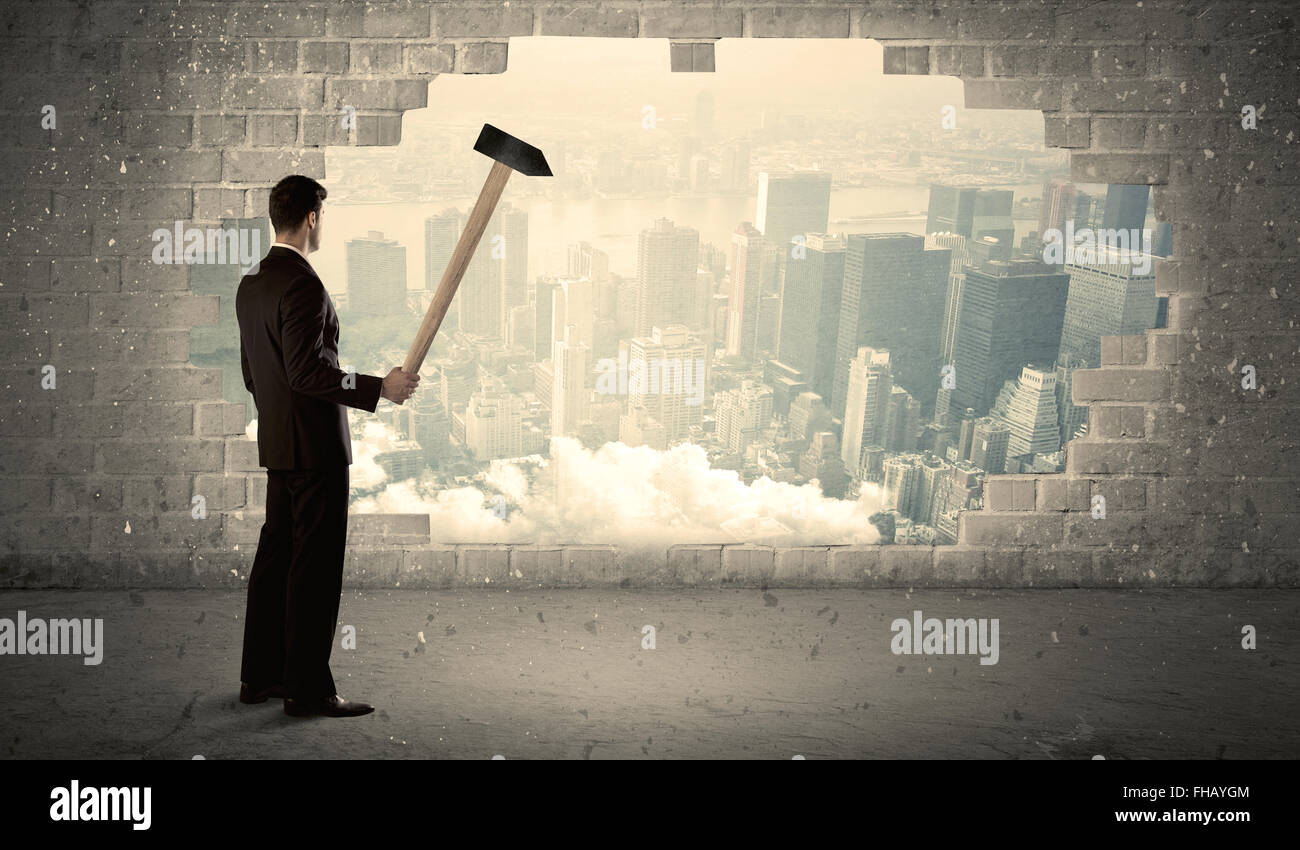 Business man hitting wall with hammer on city view Stock Photo - Alamy