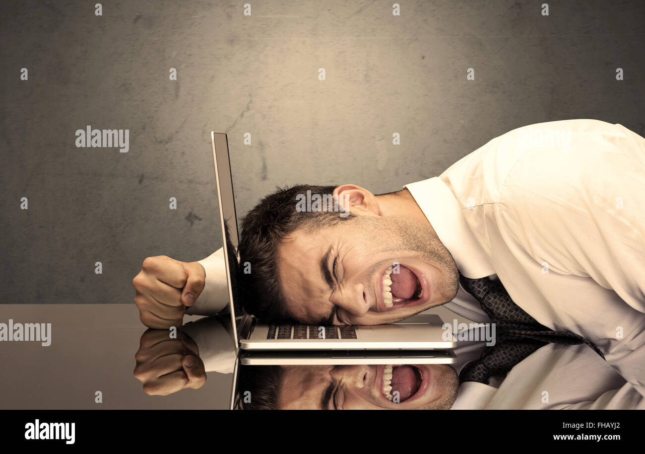 Frustrated businessman's head on keyboard Stock Photo - Alamy