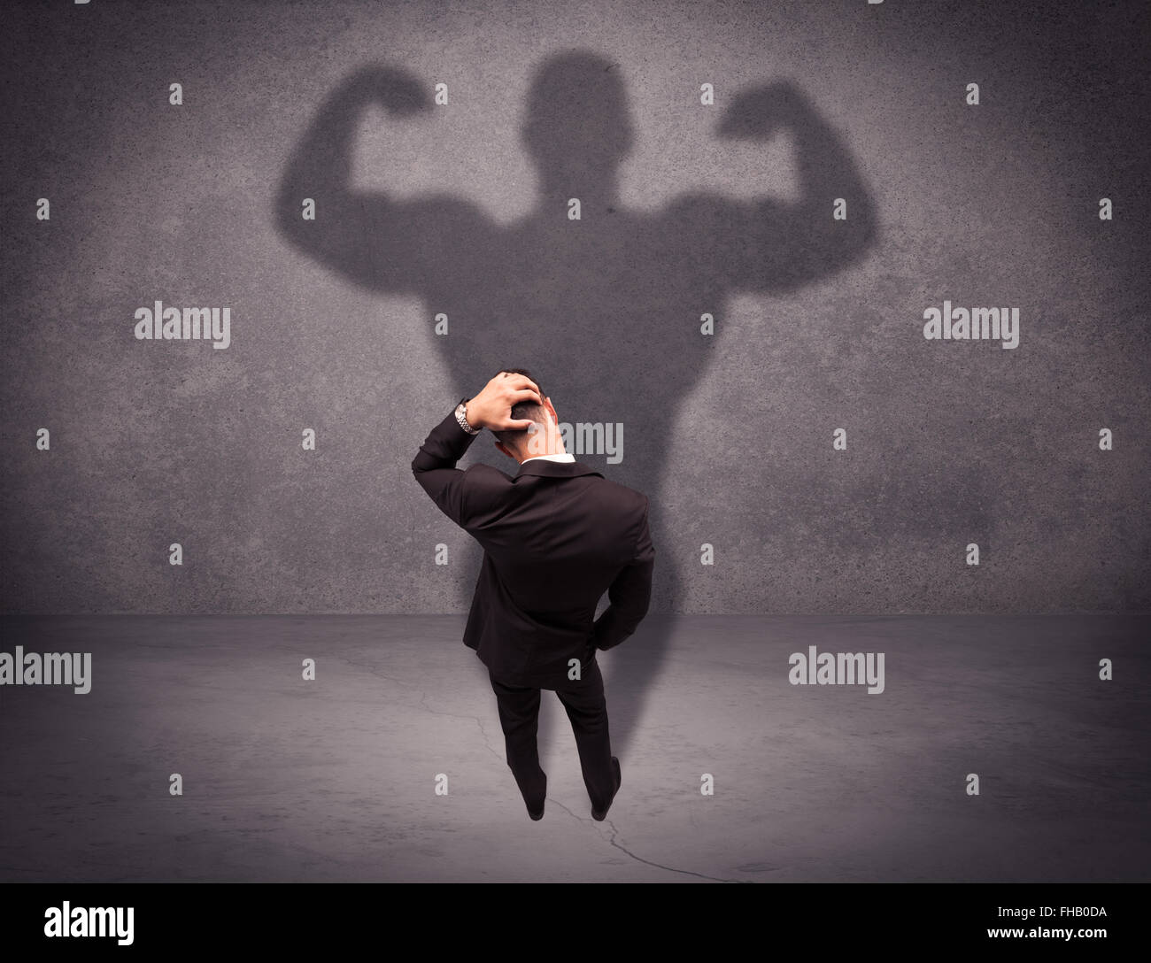 Successful businessman with strong shadow Stock Photo - Alamy