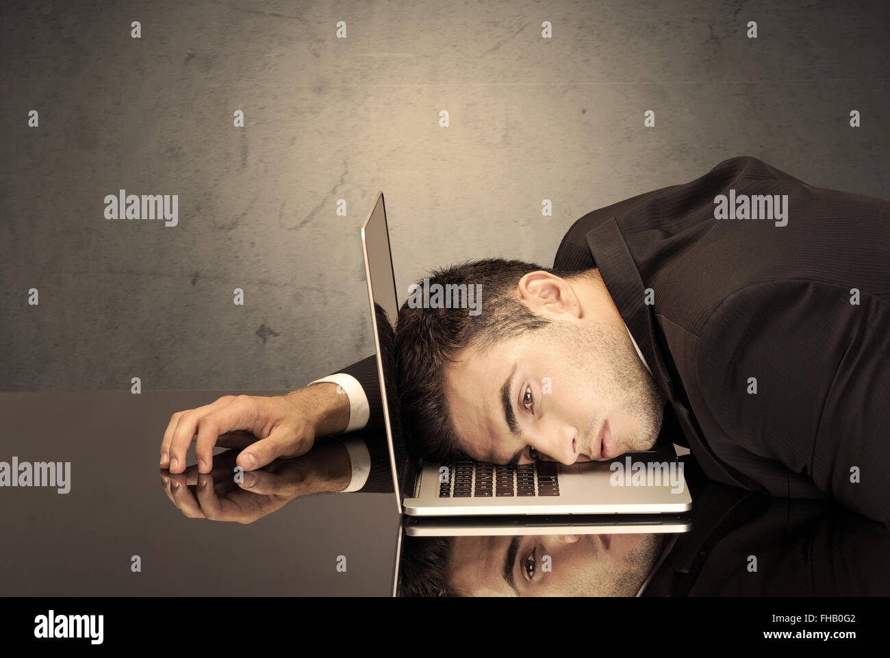 Frustrated businessman's head on keyboard Stock Photo - Alamy